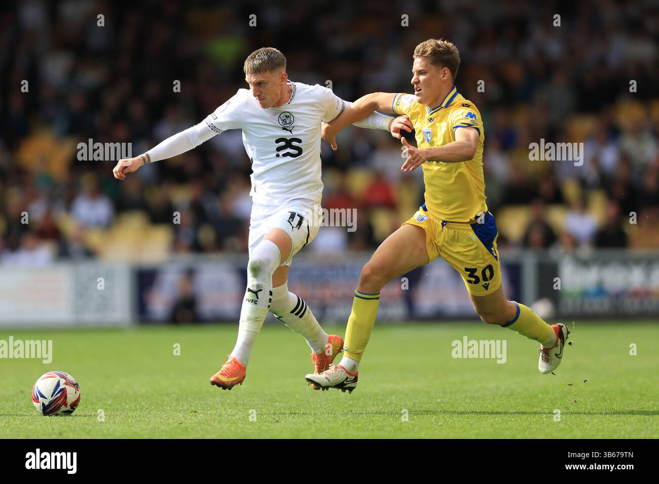 Port Vale's Ronan Curtis (left) and Gillingham's Sam Gale battle for ...