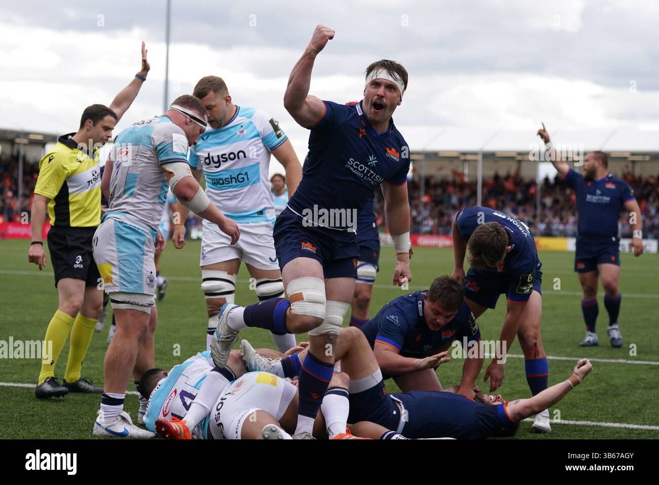 Edinburgh Rugby’s Ali Price (bottom, centre) celebrates scoring a try ...