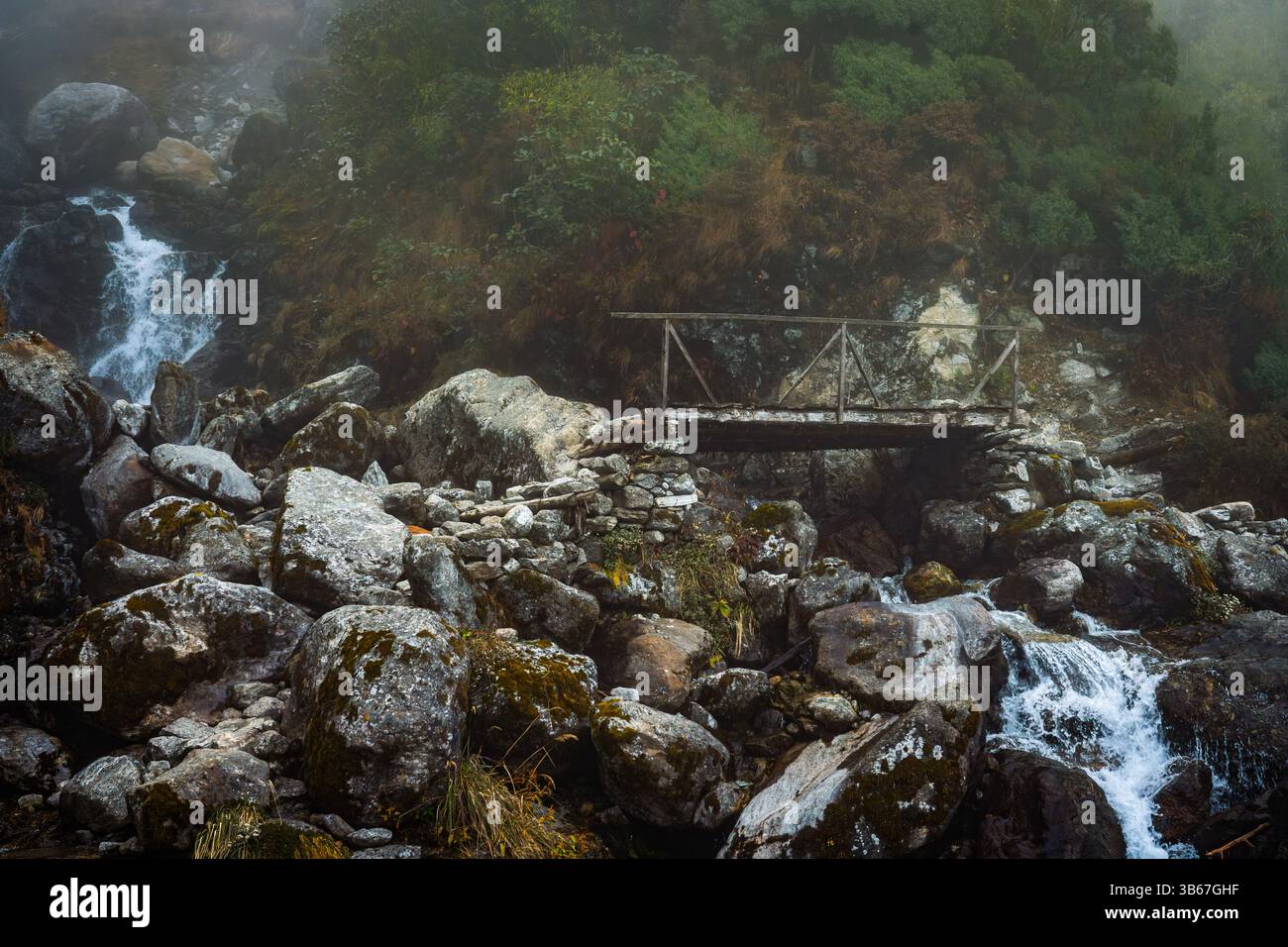 Beautiful Himalayan Glacial Waterfalls in the Mountains with a Bridge ...