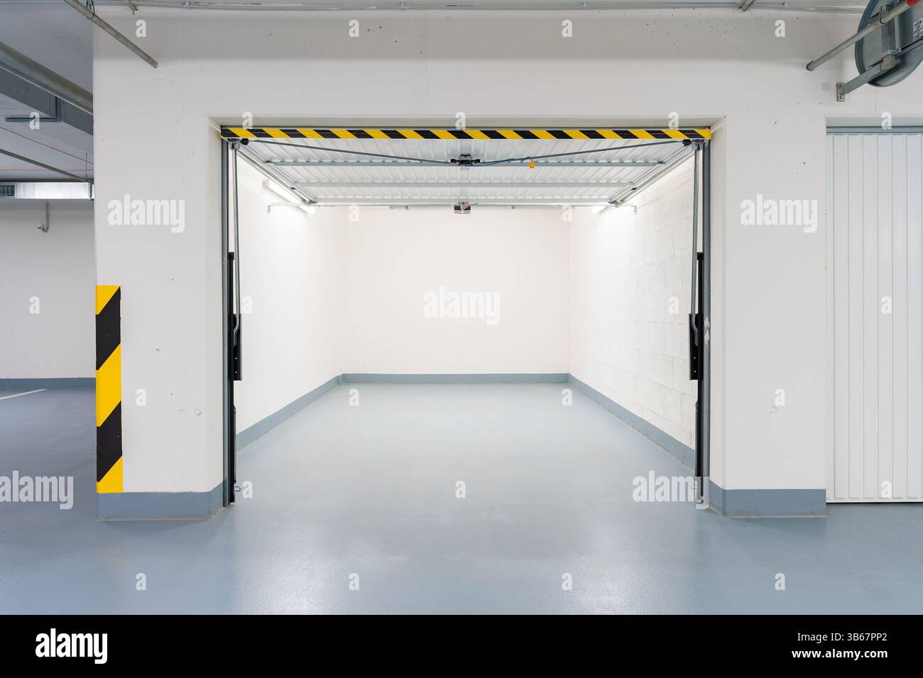 Clean, modern underground garage in a Czech apartment building with ...