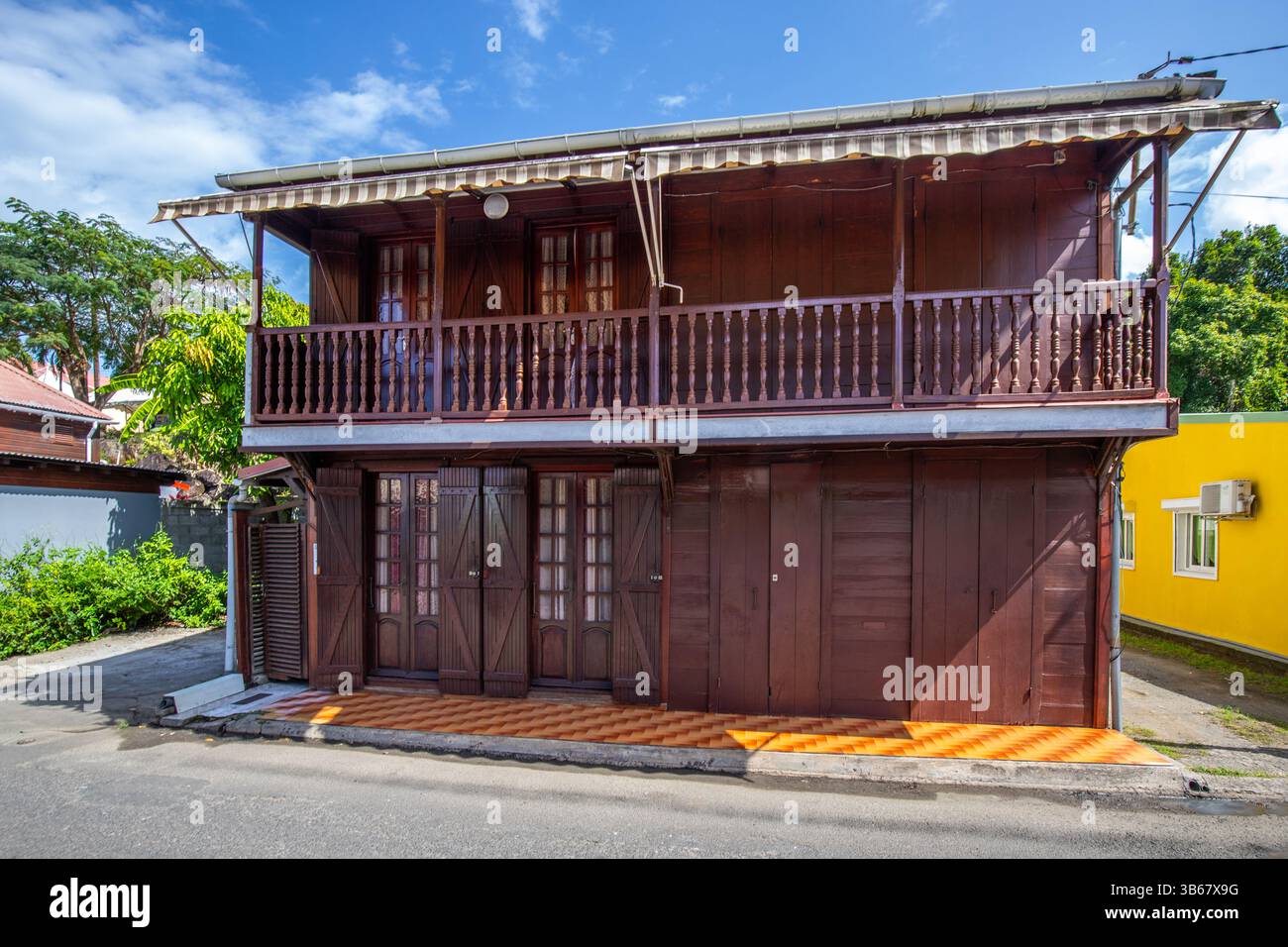 Deshaies, historic Caribbean wooden buildings on a street in Guadeloupe ...