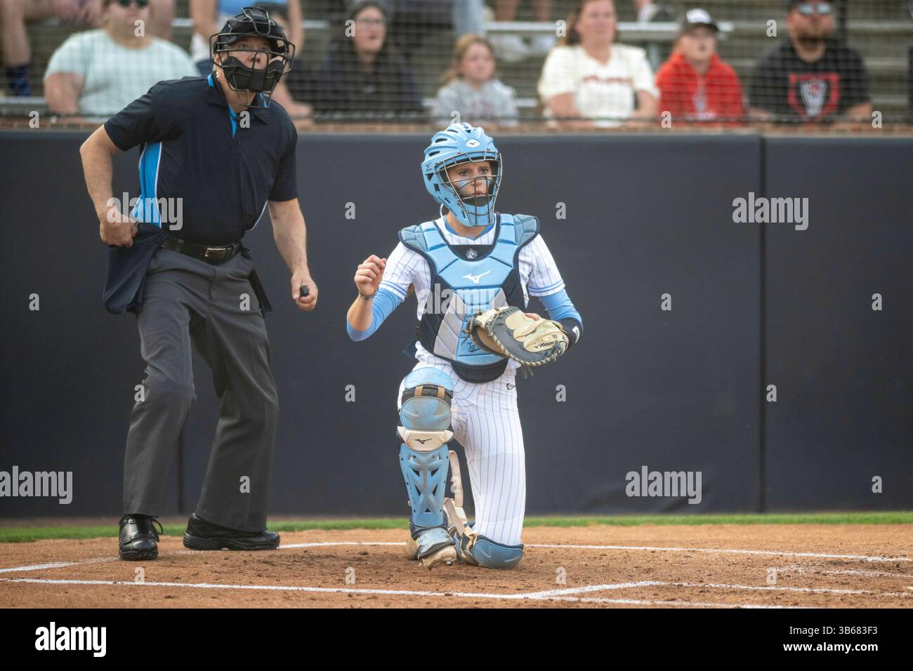 Umpire Mario Calabrese and University of North Carolina Tar Heel Catcher Rayna Blackwell (7 ...