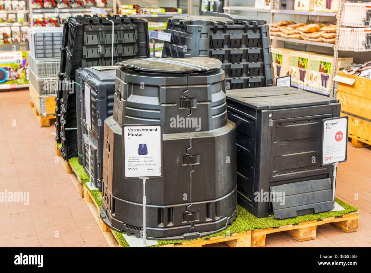 Black compost bins and thermal composters on display in gardening store ...