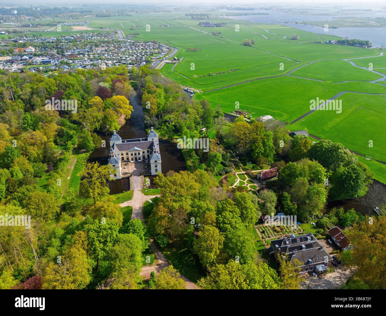 Aerial view of a historic castle surrounded by a forest, with vast ...