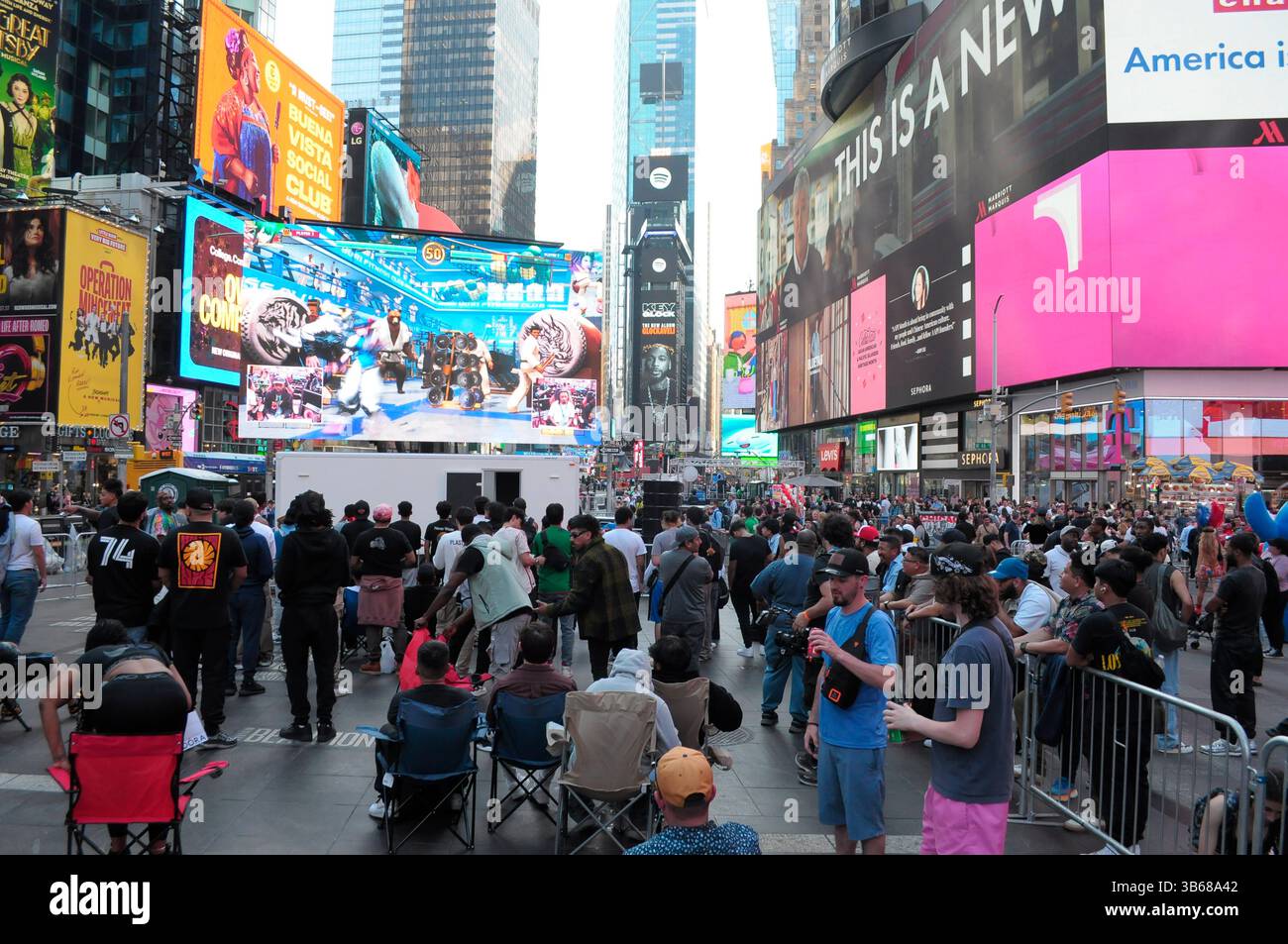 New York, USA. 2nd May, 2025. A crowd of people watch a large TV screen ...