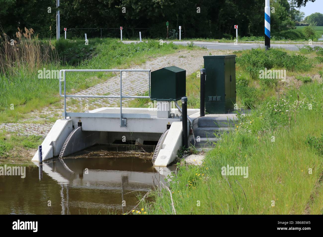 a weir in a broad ditch with water for drainage of the fields Stock ...