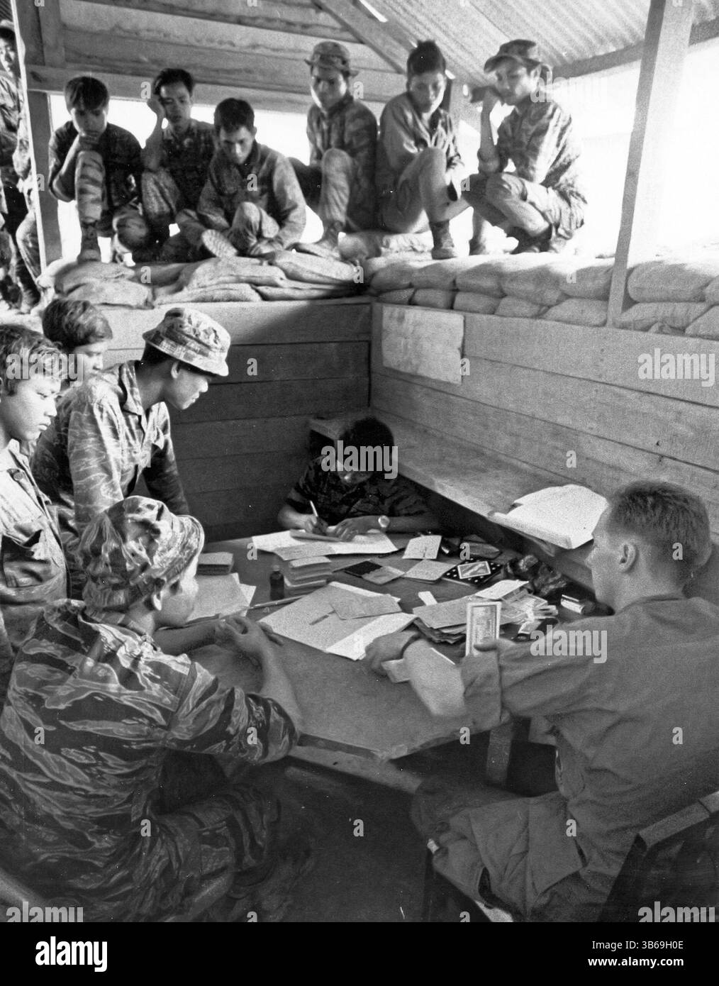 A Special Forces soldier pays Montagnard mercenaries who helped defend ...