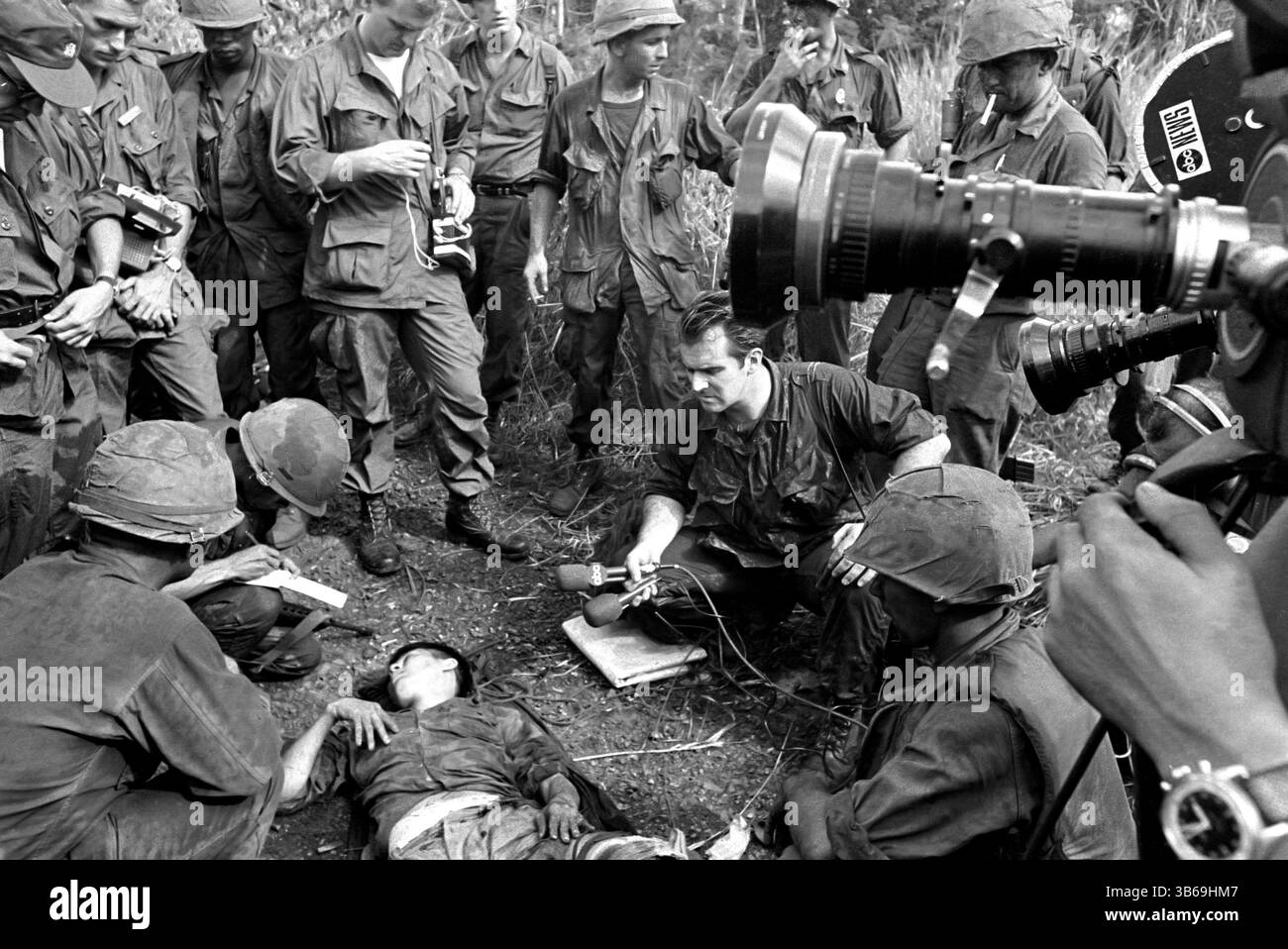 A mortally wounded North Vietnamese Army soldier is surrounded by ...