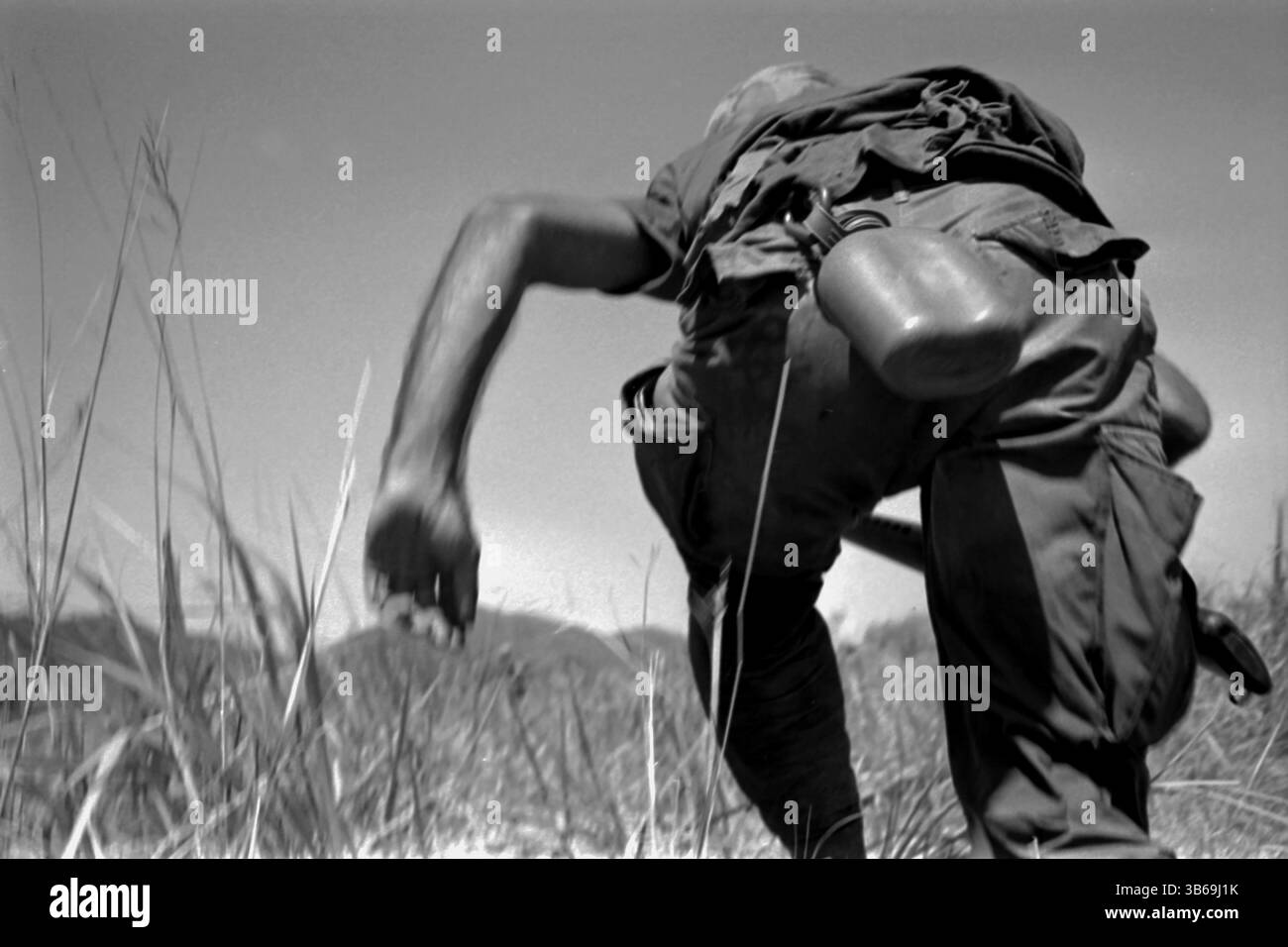 A U.S. Army soldier runs for cover during a firefight in the Hiep Duc Valley, Vietnam, 1969 ...