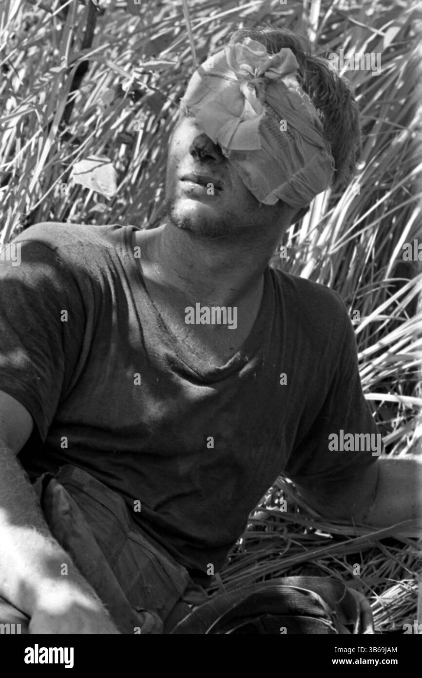 A wounded soldier waits for a medevac helicopter during the Vietnam War ...