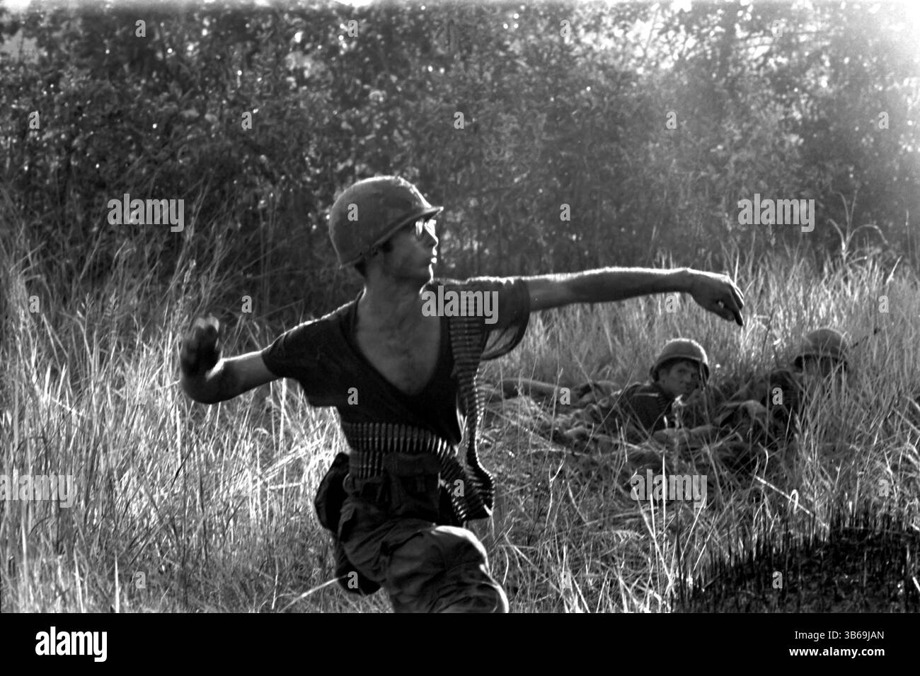 U.S. Army soldier hurls a grenade at an enemy position in the Hiep Duc ...