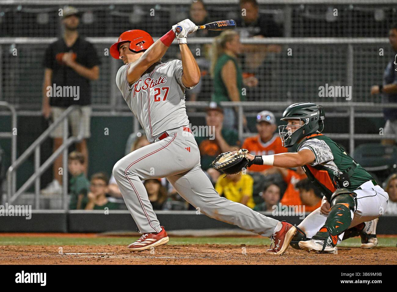CORAL GABLES, FL - MAY 02: NC State infielder Chris McHugh (27) hits a single in the eighth ...