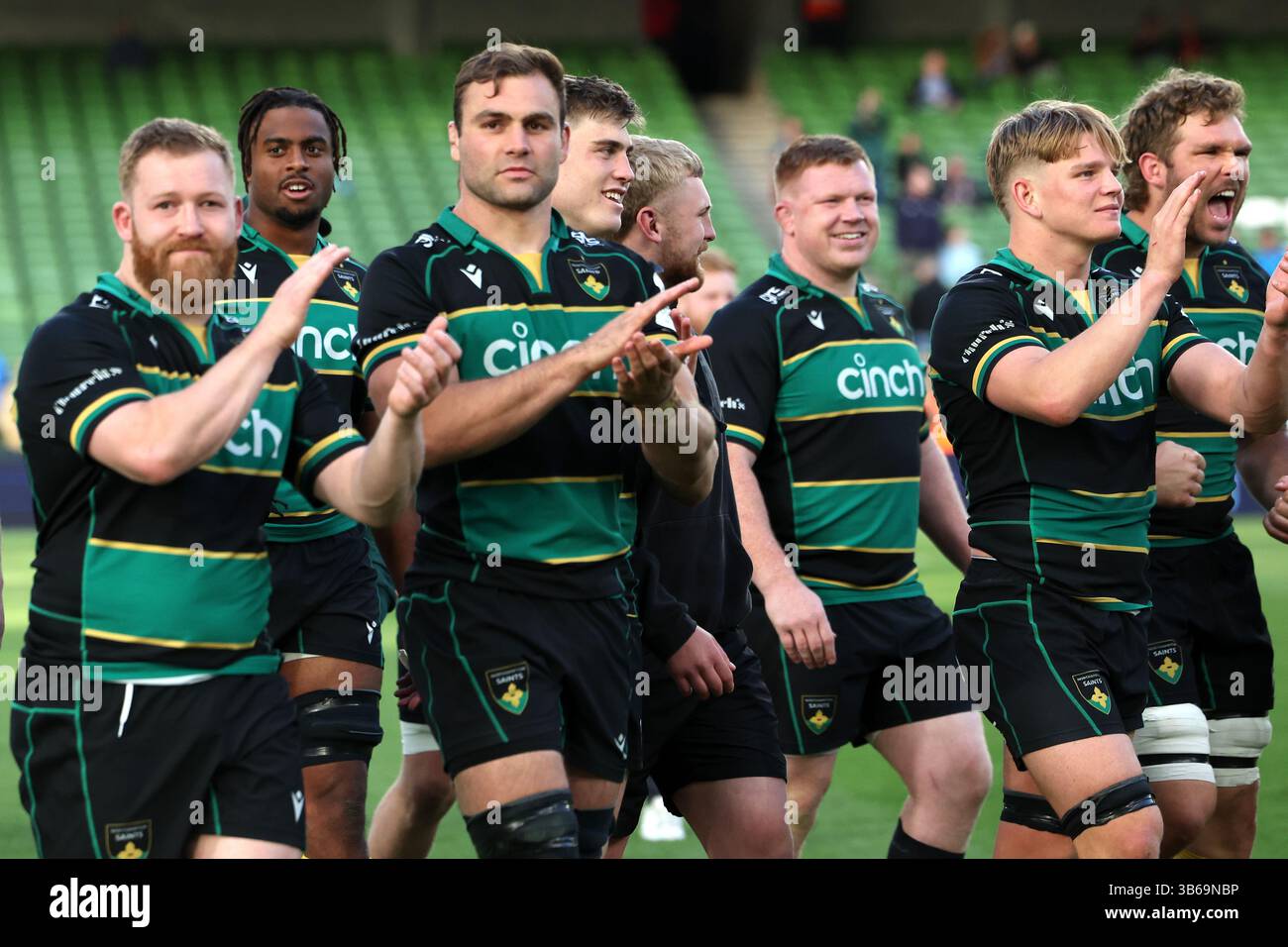 Northampton Saints players applaud the fans following victory in the ...
