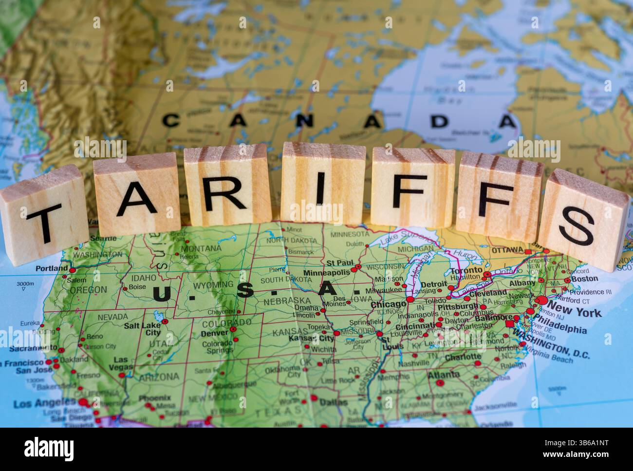 A map of the USA and Canada with letter wood tiles forming the word ...