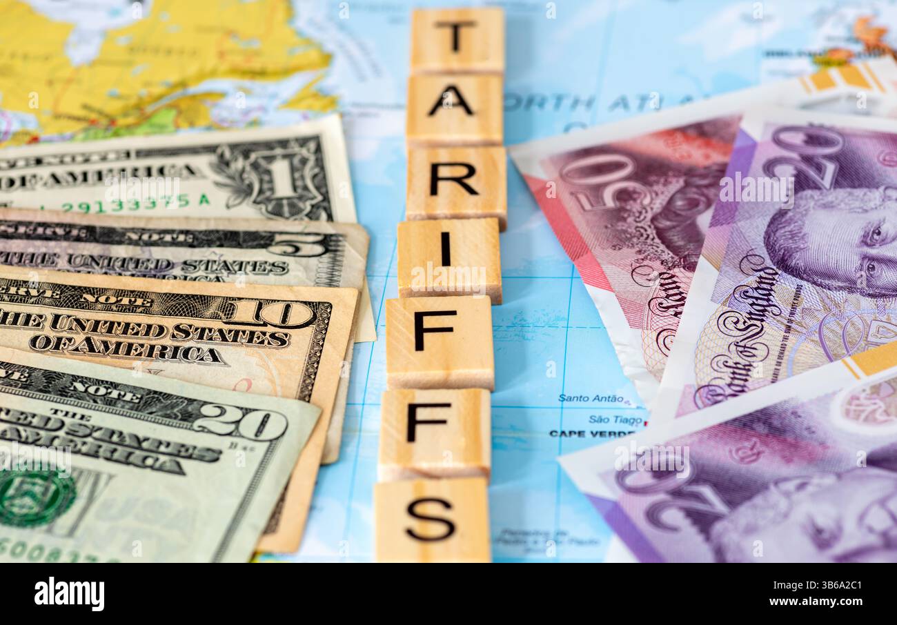 Letter wood tiles on a map forming the word tariffs with US dollar ...