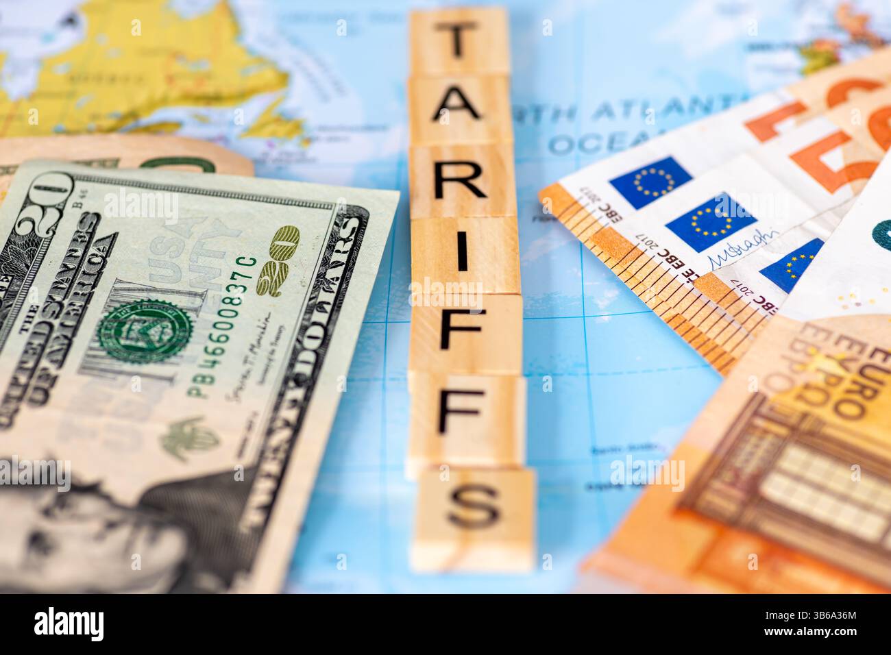 Letter wood tiles on a map forming the word tariffs with US dollar ...