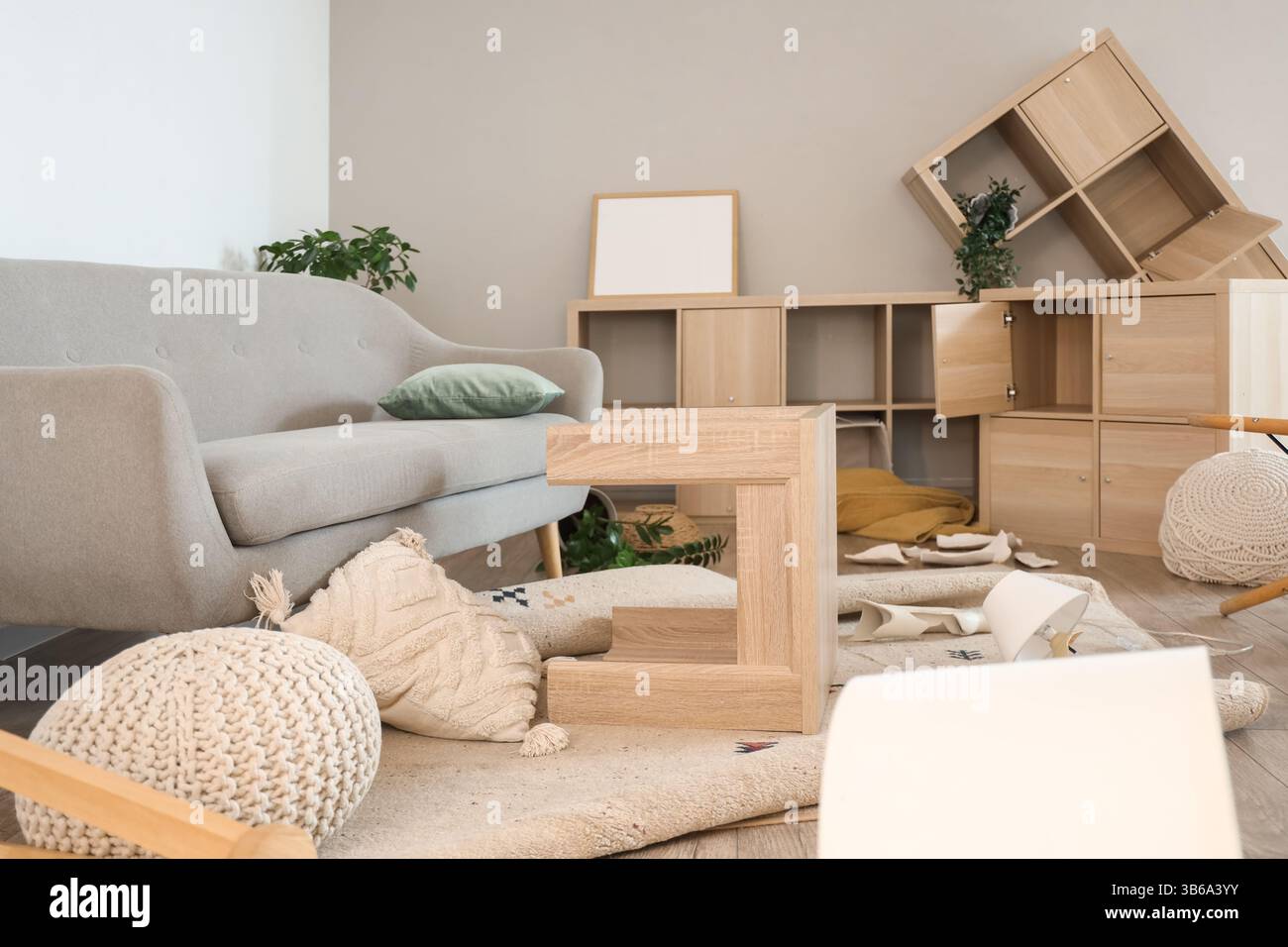 Interior of messy living room with overturned furniture after ...