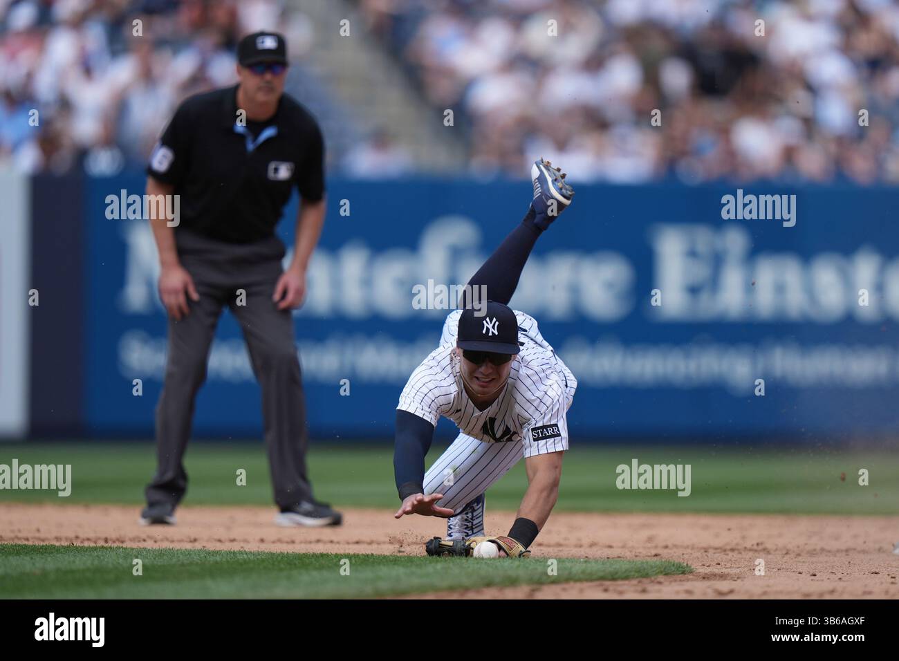 New York Yankees' Anthony Volpe loses control of the ball on a fielding ...