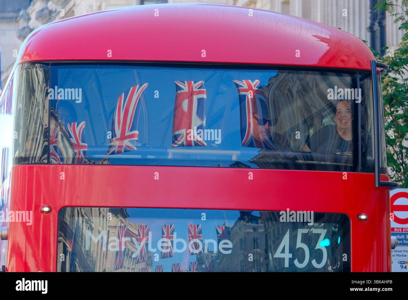 London, UK. 3rd May, 2025. Reflections of Union flags in the front bus ...