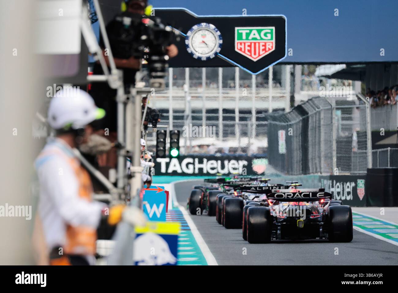 Drivers line up to leave the pit area during the qualifying session for ...