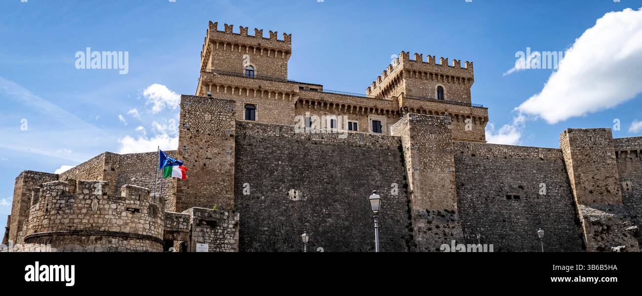 A historic stone castle with towers and battlements under a blue sky ...