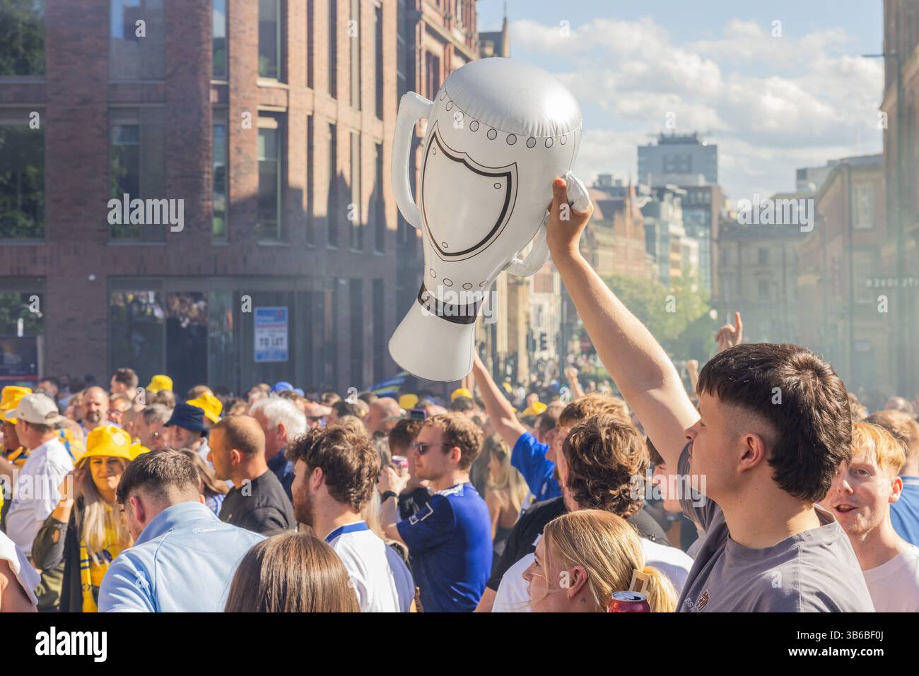 Leeds, UK. 03 MAY, 2025. Man lifts inflatable trophy as Leeds United ...