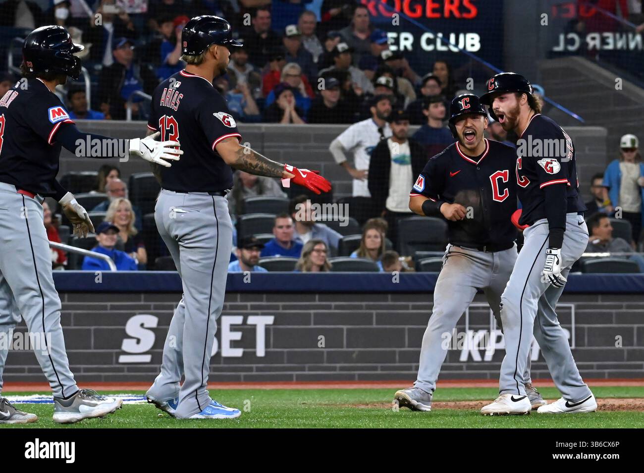 Cleveland Guardians' Daniel Schneemann, right, celebrates hitting a ...