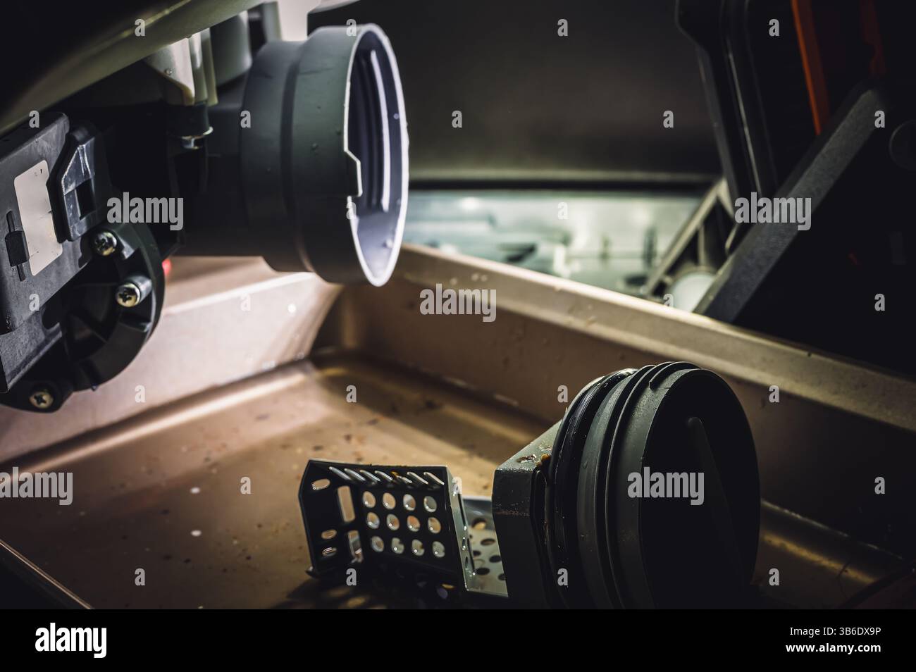 Cleaning and draining a clothes washing machine filter Stock Photo - Alamy