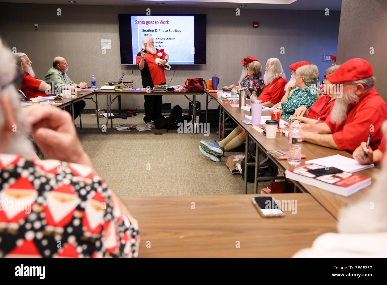 Using a hat as a prop, instructor National Santa Tim Connaghan shows ...