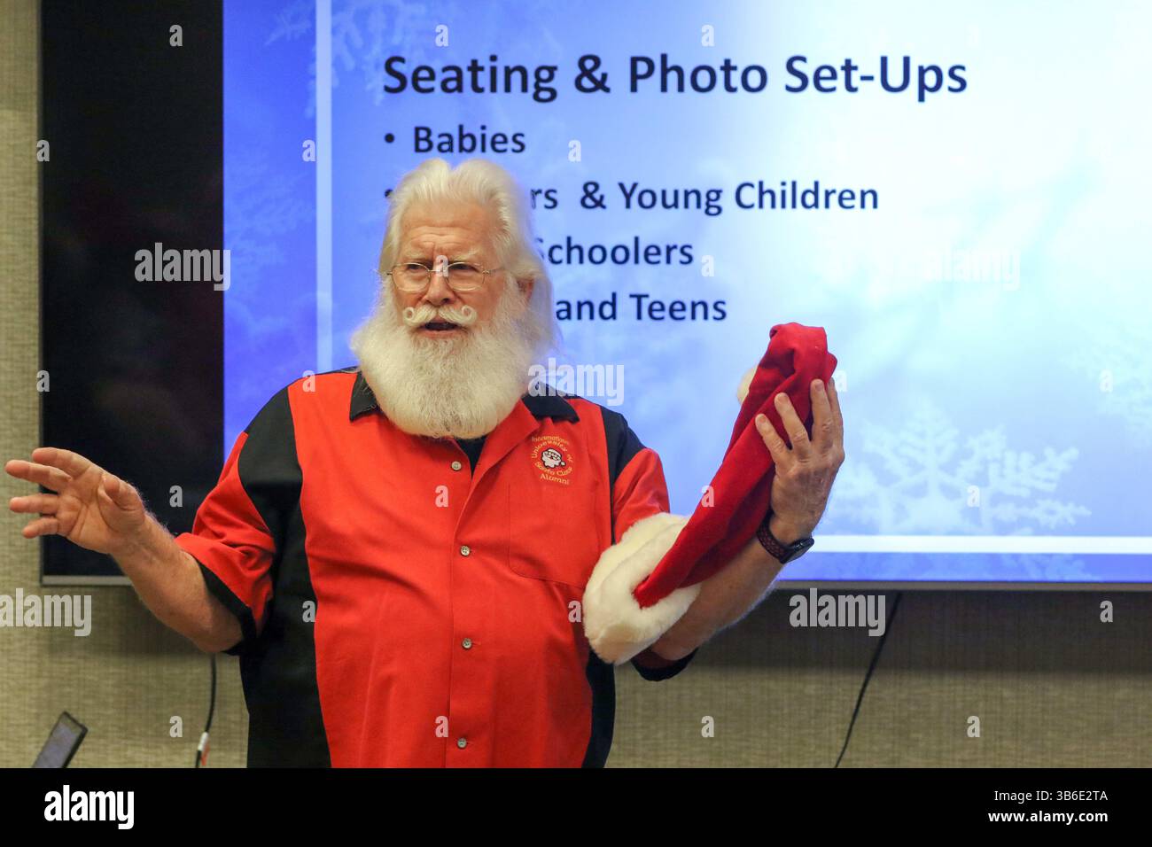 Using a hat as a prop, instructor National Santa Tim Connaghan shows ...