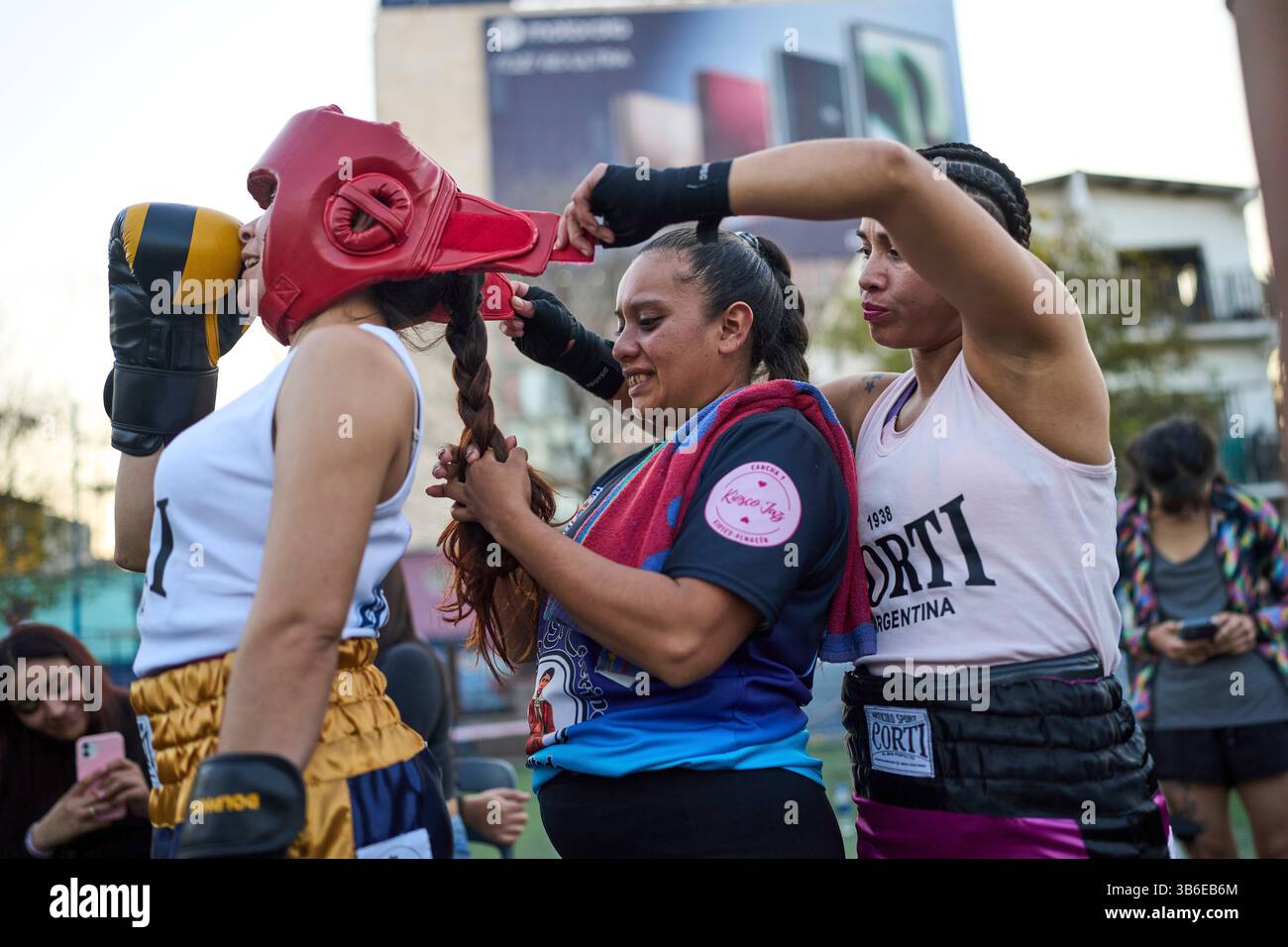 Collegues help Rachel Vazquez, 25, secure her padded helmet as she ...