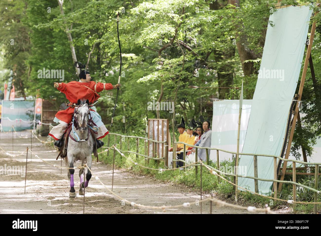 An archer shoots an arrow while riding a horse during the "Yabusame ...