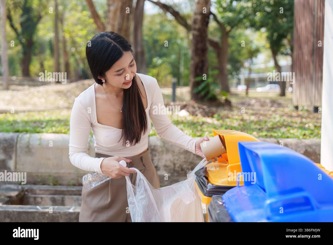Environmental Responsibility and Waste Sorting. A woman organizes her ...