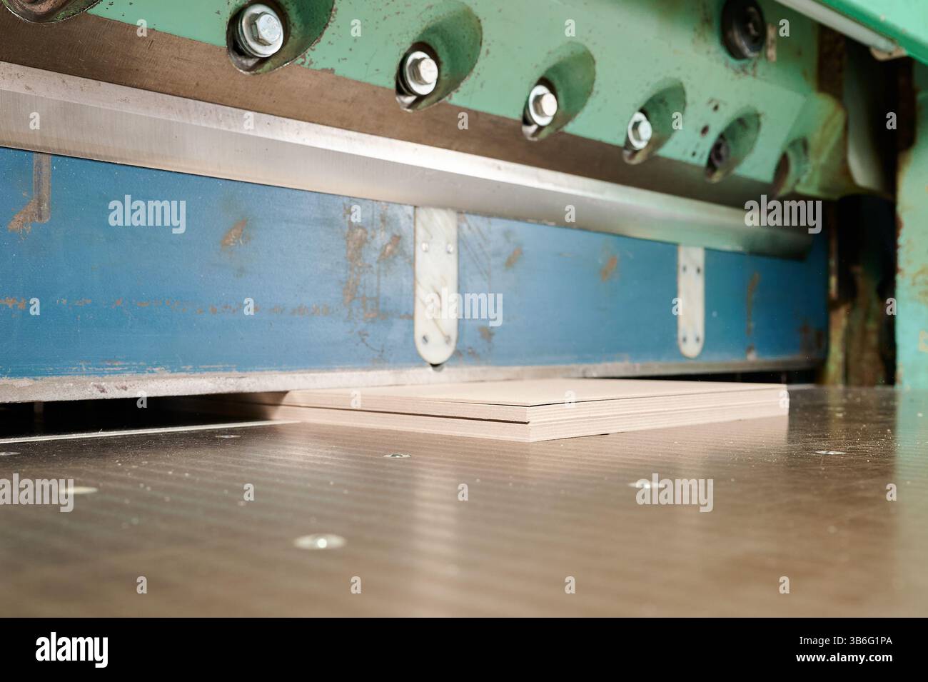 Cutting cardboard sheets on guillotine shears for precision crafting in ...