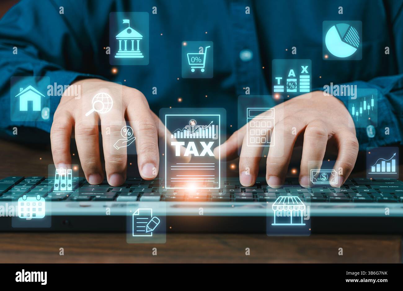 A businessman calculates taxes using a calculator and a computer ...