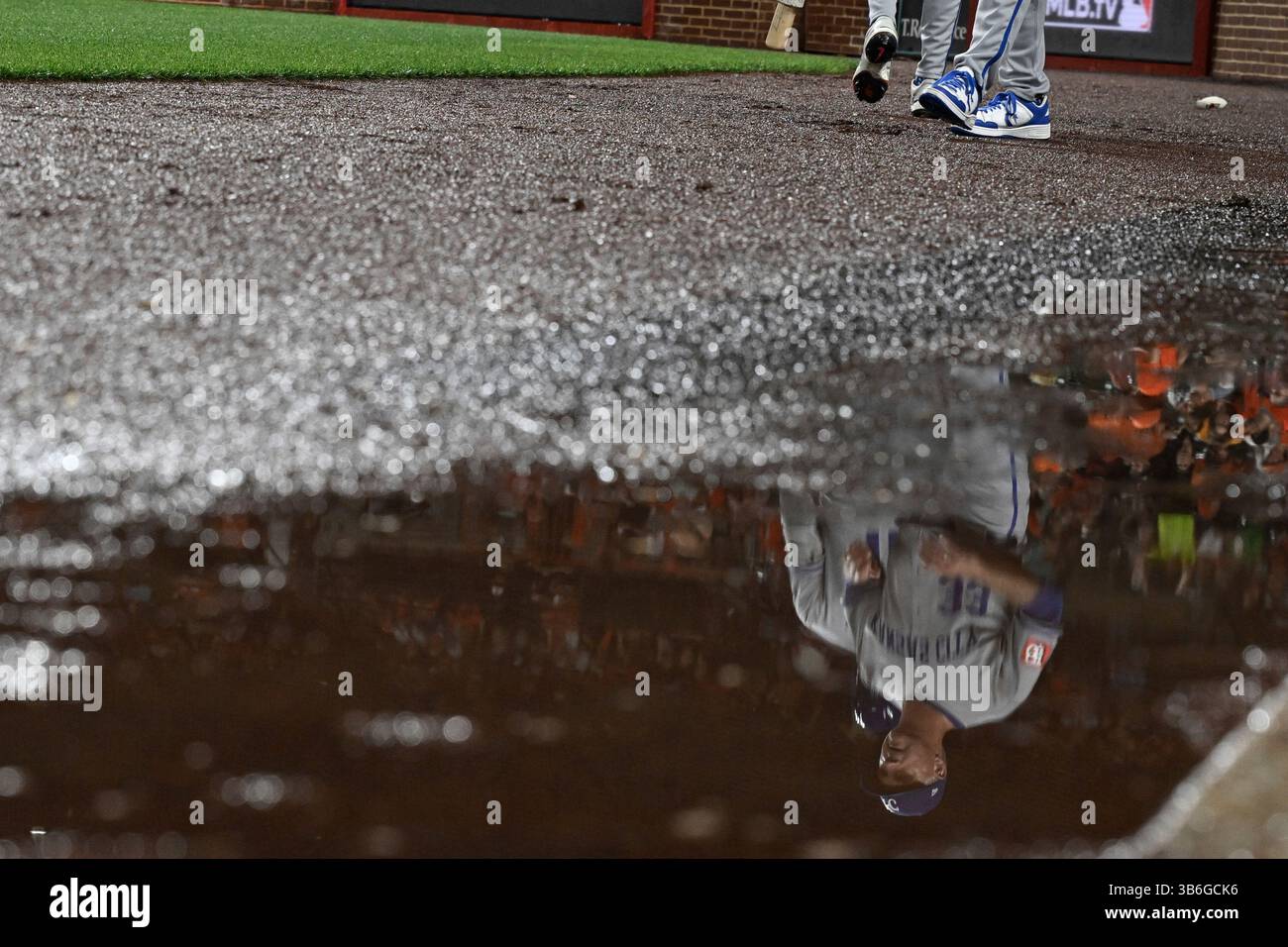 The reflection of Kansas City Royals manager Matt Quatraro is seen in a ...