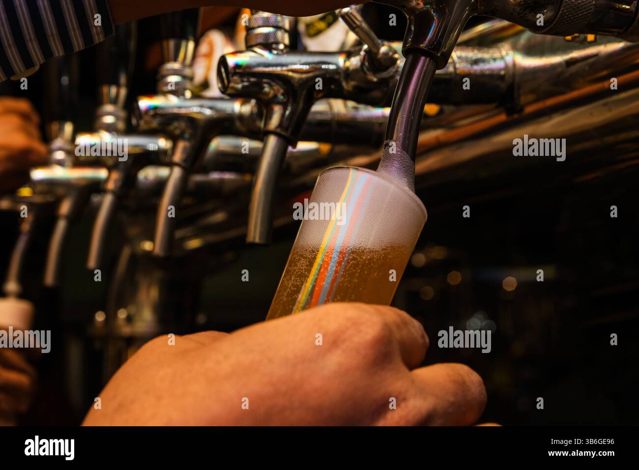 fresh draught beer is pouring into glass Stock Photo - Alamy