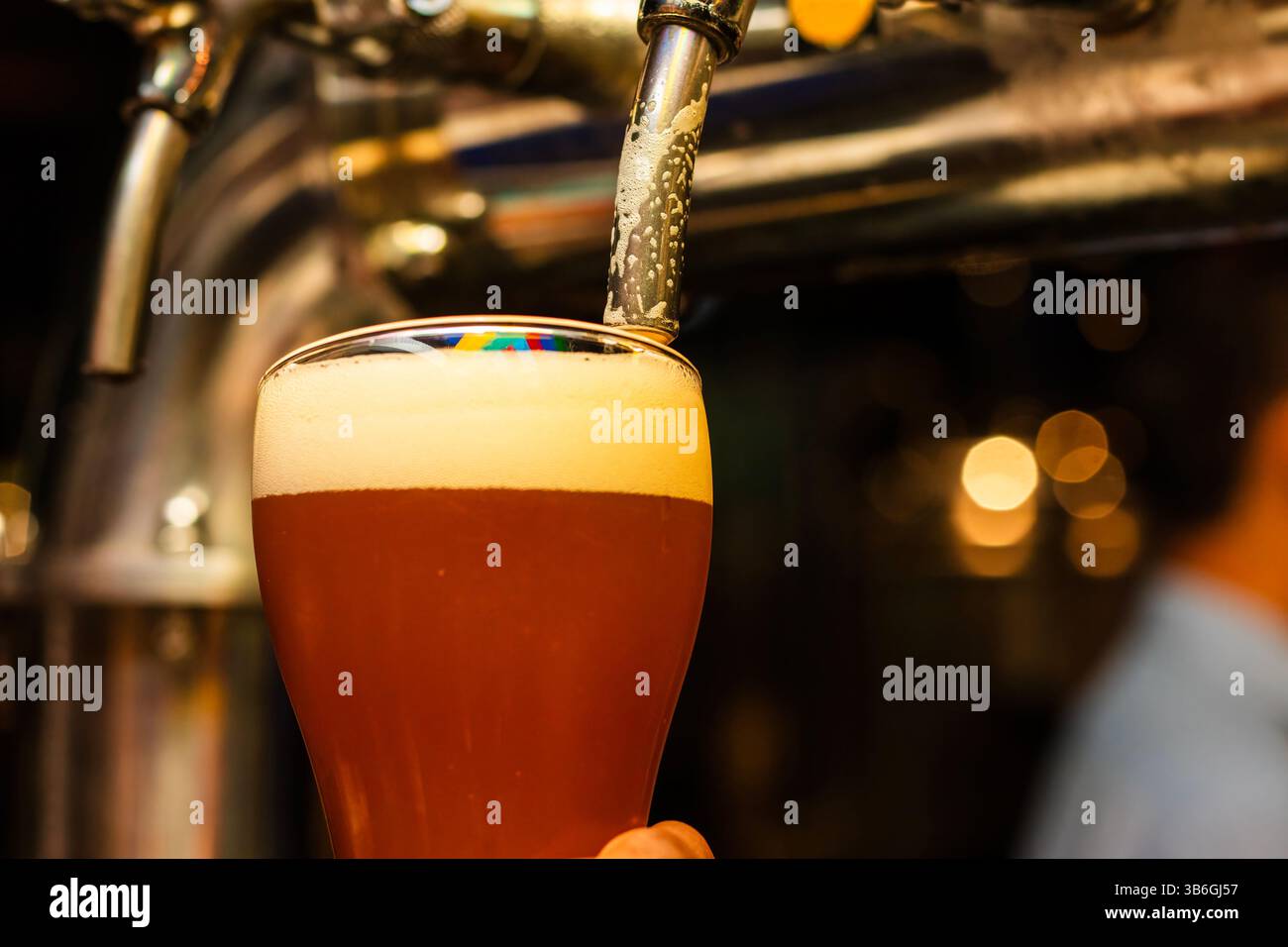 fresh draught beer is pouring into glass Stock Photo - Alamy