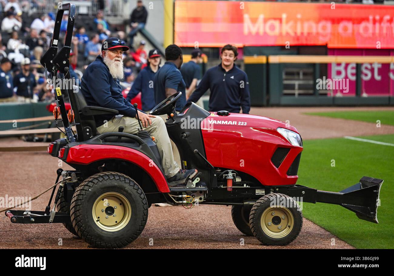 ATLANTA, GA – MAY 03: A member of the Braves grounds crew prepares to ...