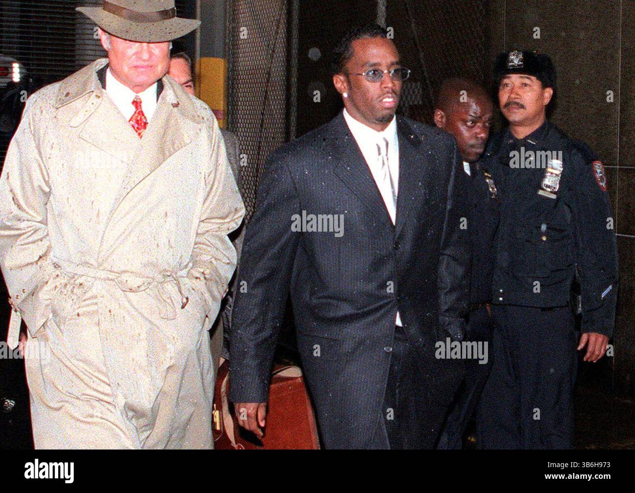FILE - Rap artist and music producer Sean "Puffy" Combs, center, leaves ...