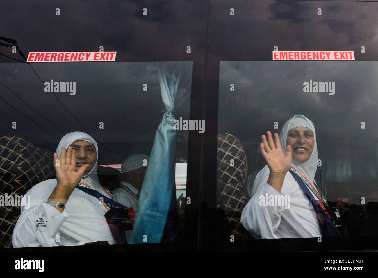 Kashmiri Muslim pilgrims wave to relatives and others as the first ...
