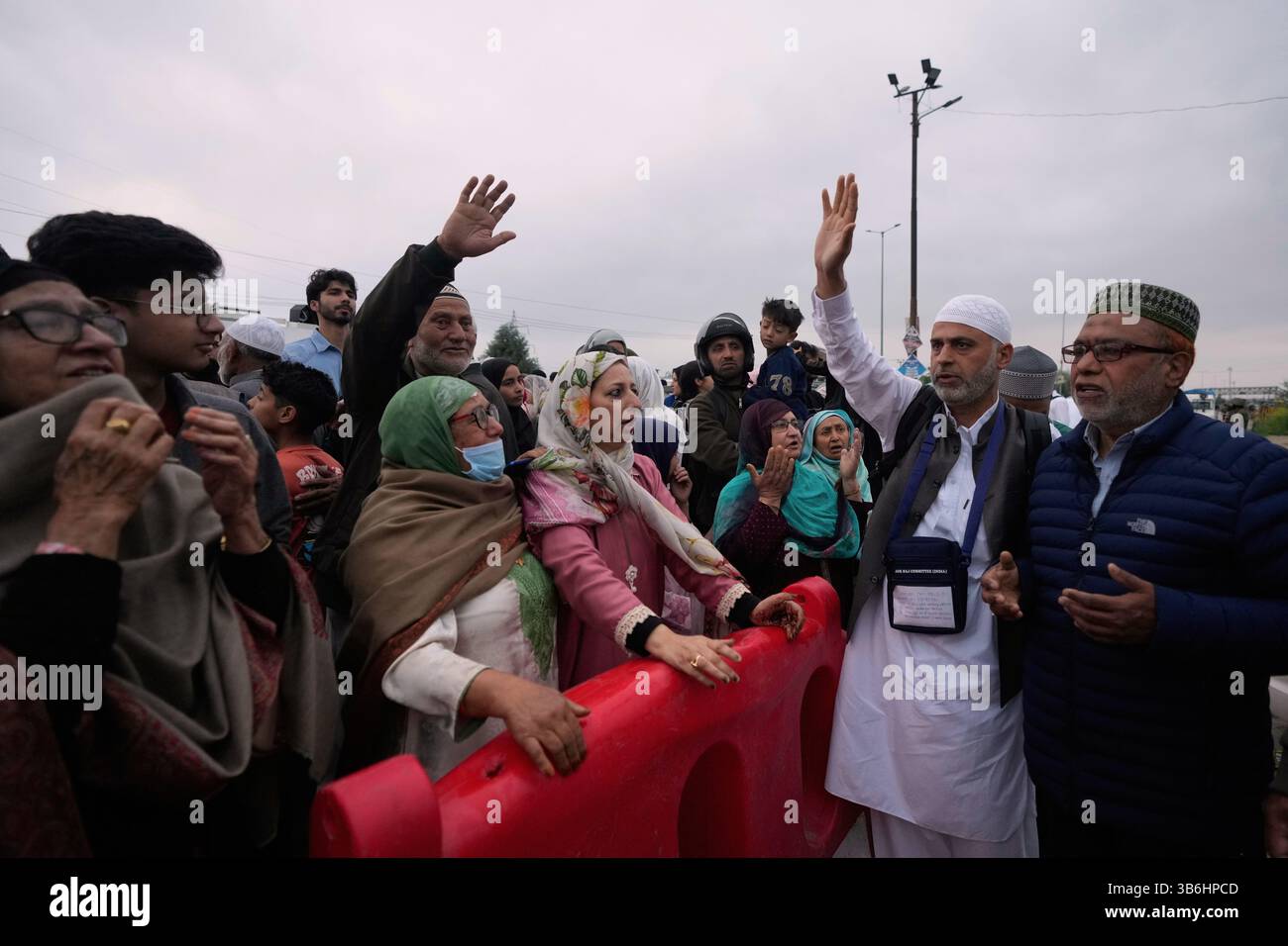 Kashmiri Muslim pilgrims wave to relatives and others as the first ...