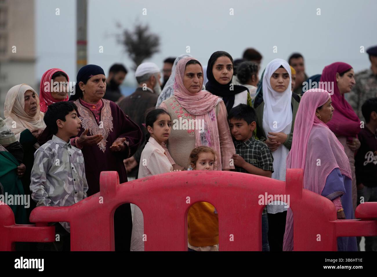 Family members and relatives of Kashmiri Muslim pilgrims, look on as ...