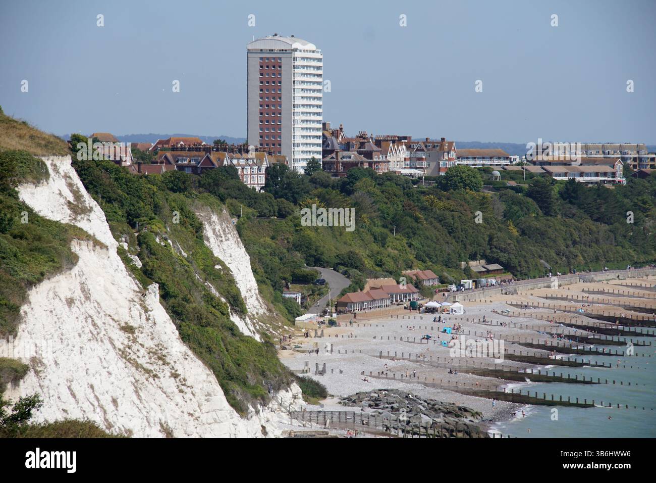 White chalk cliffs and seaside promenade with tower block in Eastbourne ...