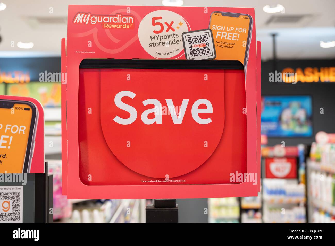 Save sign displayed in store promoting My Guardian Rewards program with ...