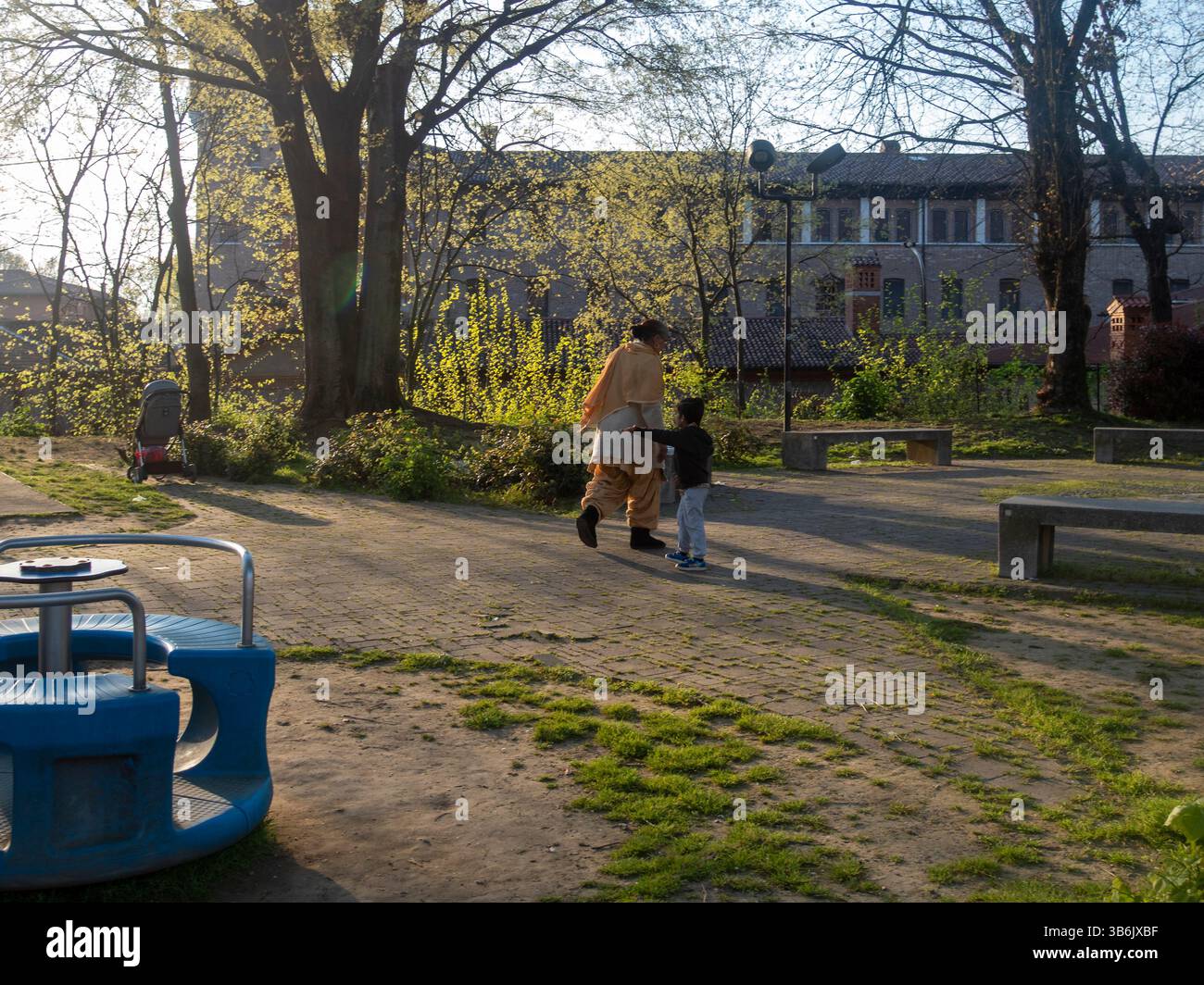 Pontevico, Italy - April 12th 2025 Children Playing on a Merry-Go-Round ...