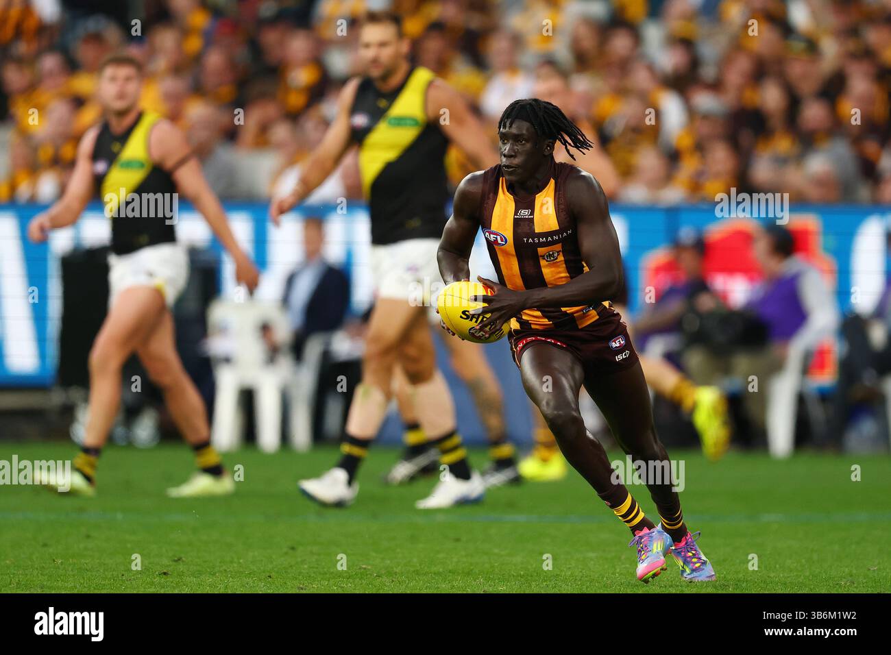 Changkuoth Jiath of the Hawks runs with the ball during the AFL Round 8 ...
