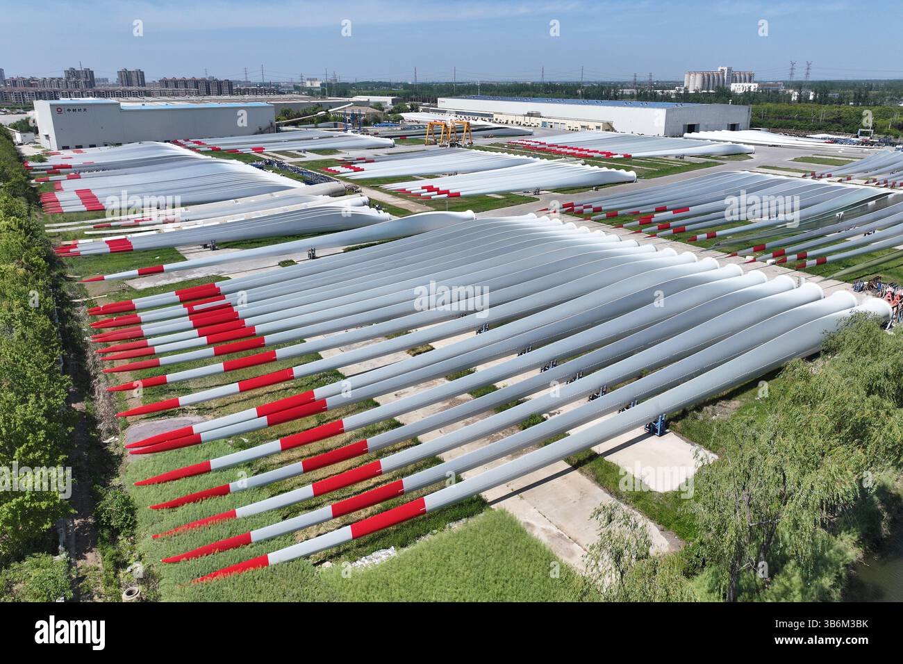 Aerial view of wind turbine blades piled up in a wind turbine blade ...