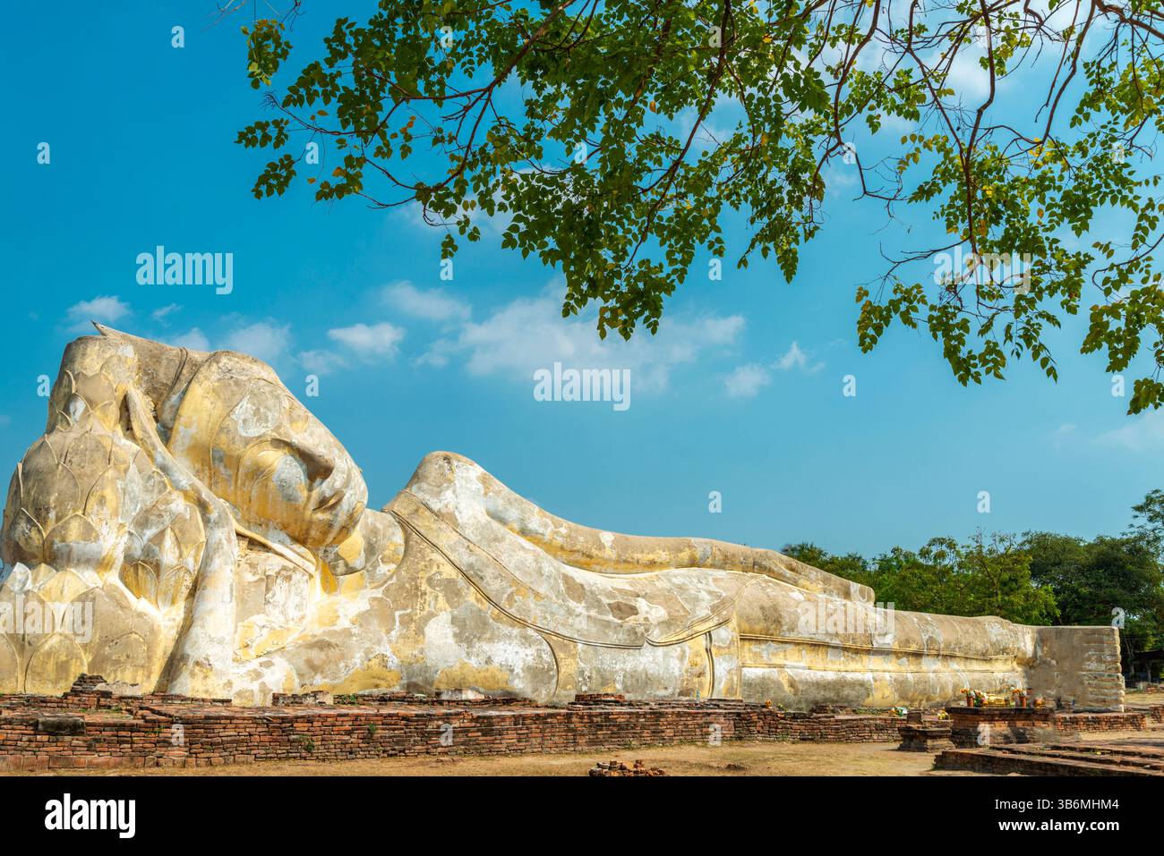 Laying in repose in the afternoon sun,under blue skies,the huge stone ...