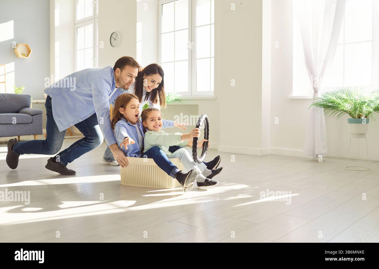 Happy parents pushing excited kids sitting in box and pretending to ...